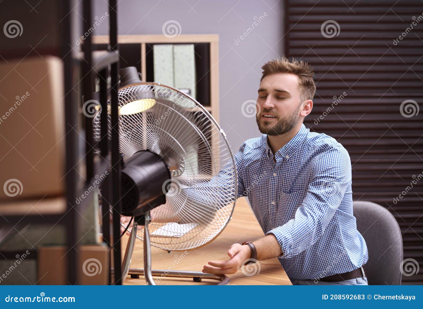 Man Enjoying Air Flow from Fan at Workplace Stock Image - Image of ...