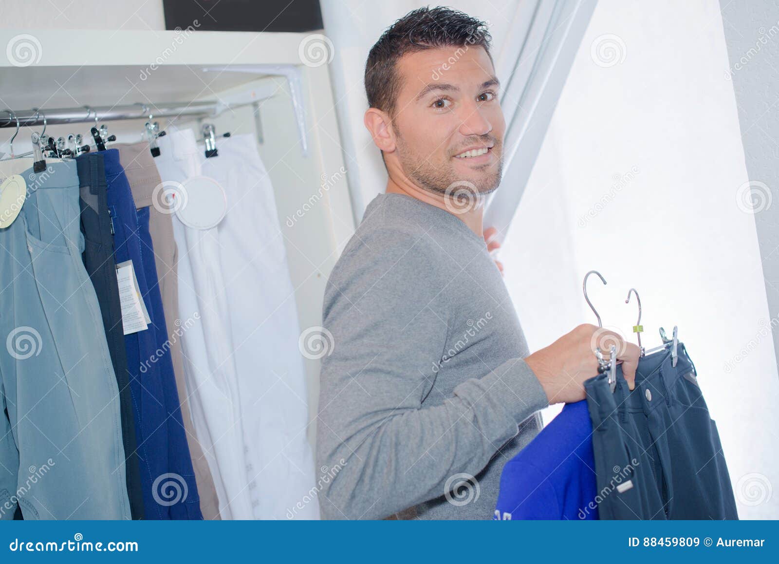 Man Entering Changing Room with Selection Clothes Stock Image - Image ...