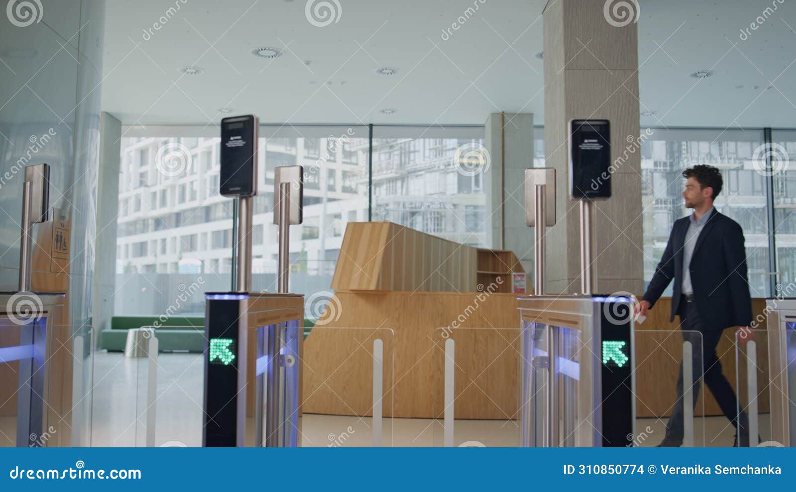 Man Entering Office Automatic Gates Using Electronic Card Reader at ...