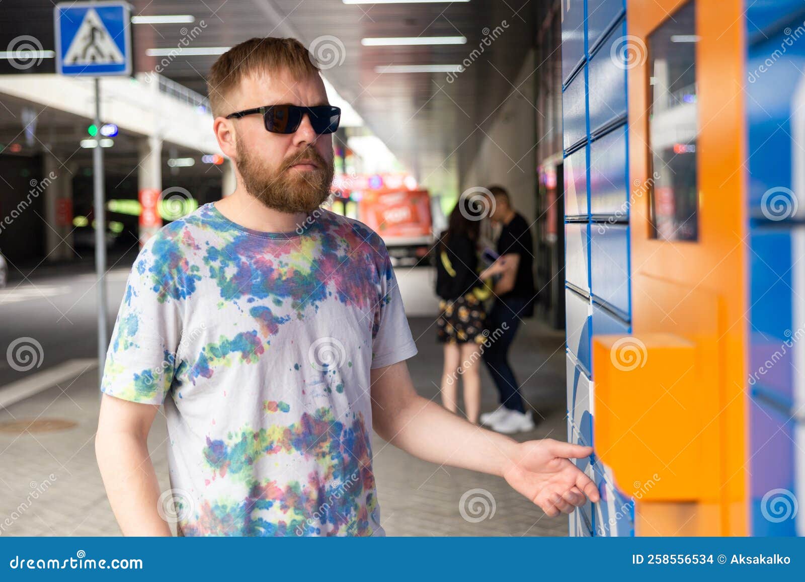 Man Enters Parcel Code on Screen and Picks Up Parcel from Automated ...