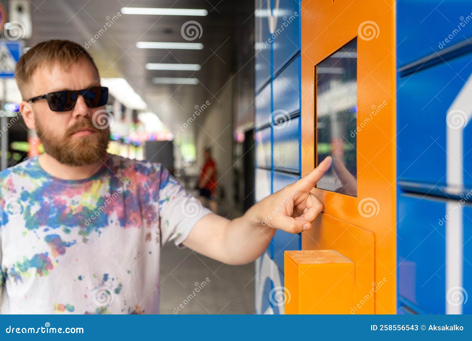 Man Enters Parcel Code on Screen and Picks Up Parcel from Automated ...