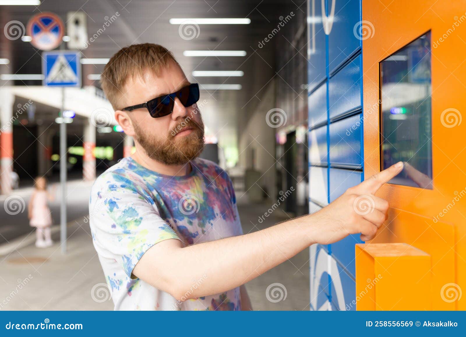 Man Enters Parcel Code on Screen and Picks Up Parcel from Automated ...