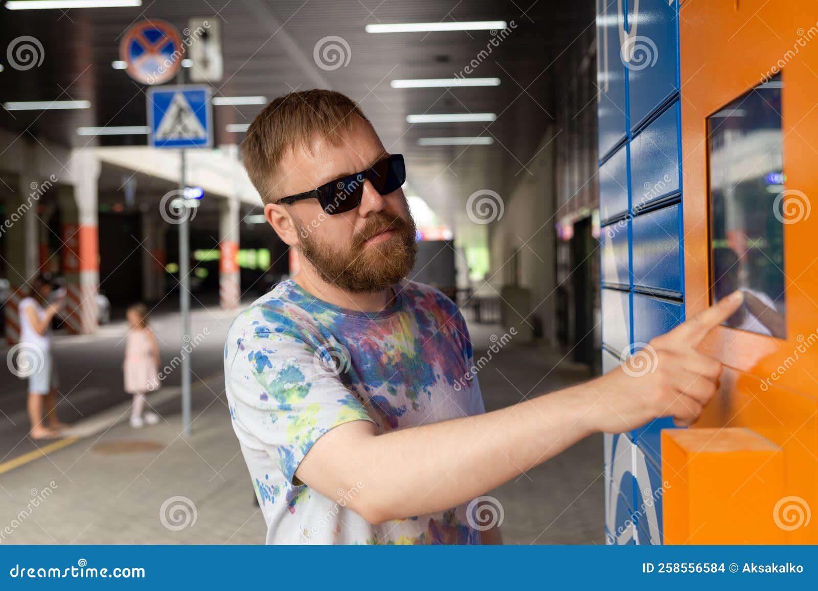 Man Enters Parcel Code on Screen and Picks Up Parcel from Automated ...