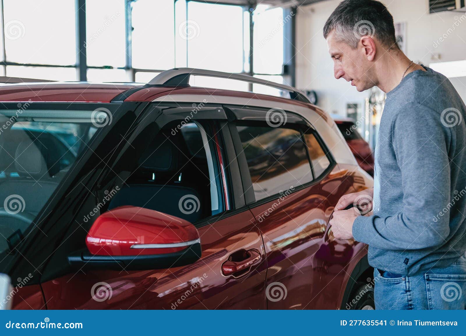 A Man Examines a Car in the Cabin for Defects. Car Rent Stock Image ...