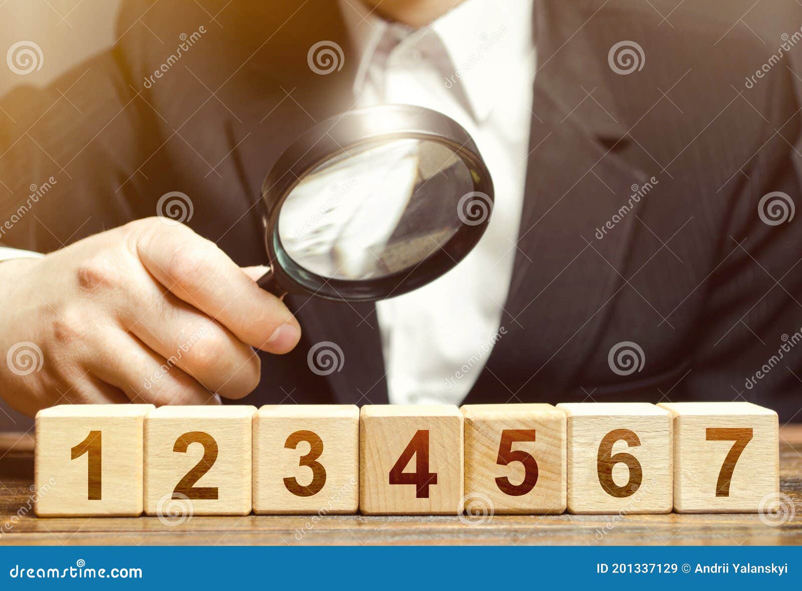 Man Examines the Numbered Blocks with a Magnifying Glass. Study ...