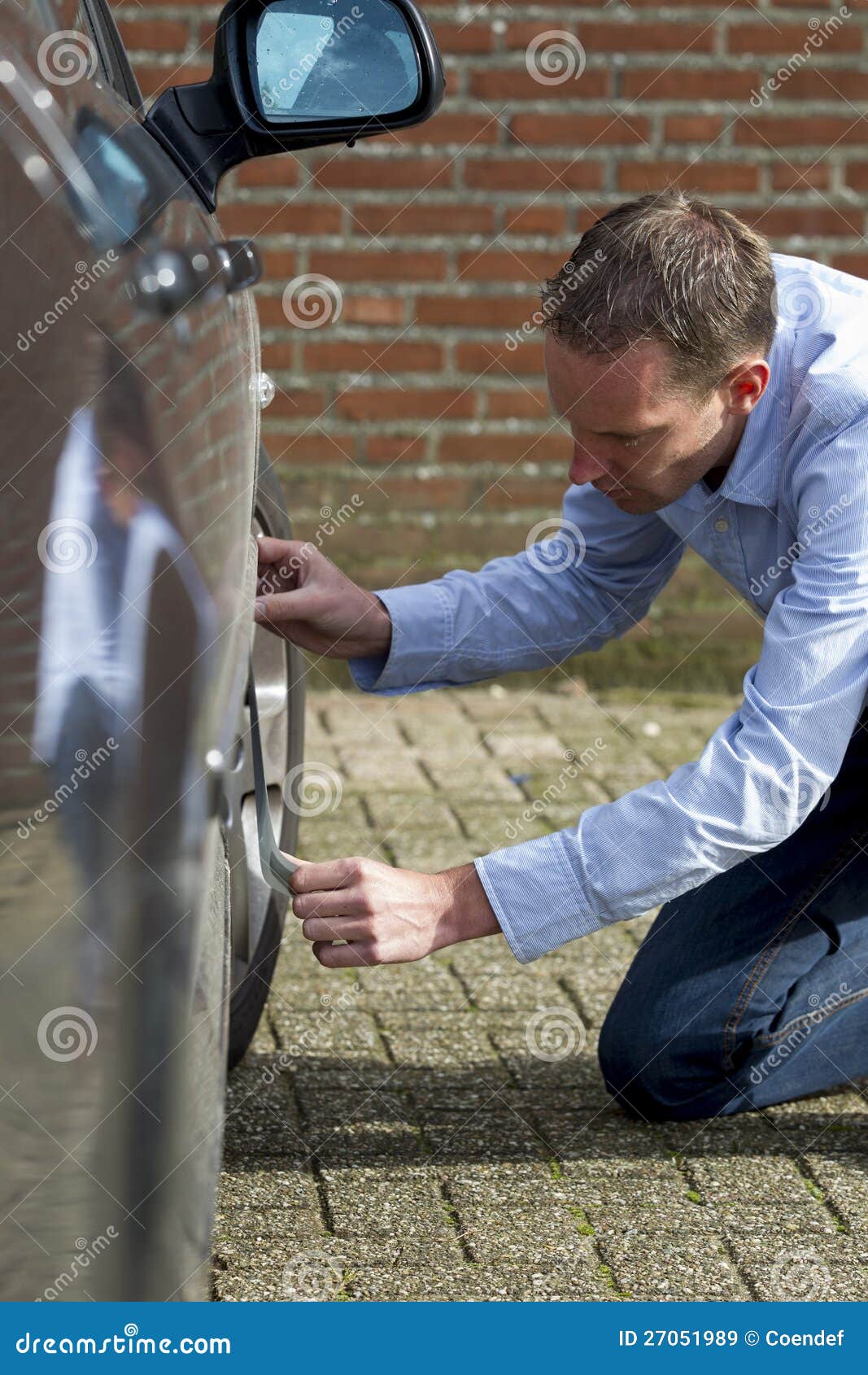 Man examining car stock image. Image of care, wheel, automobile - 27051989