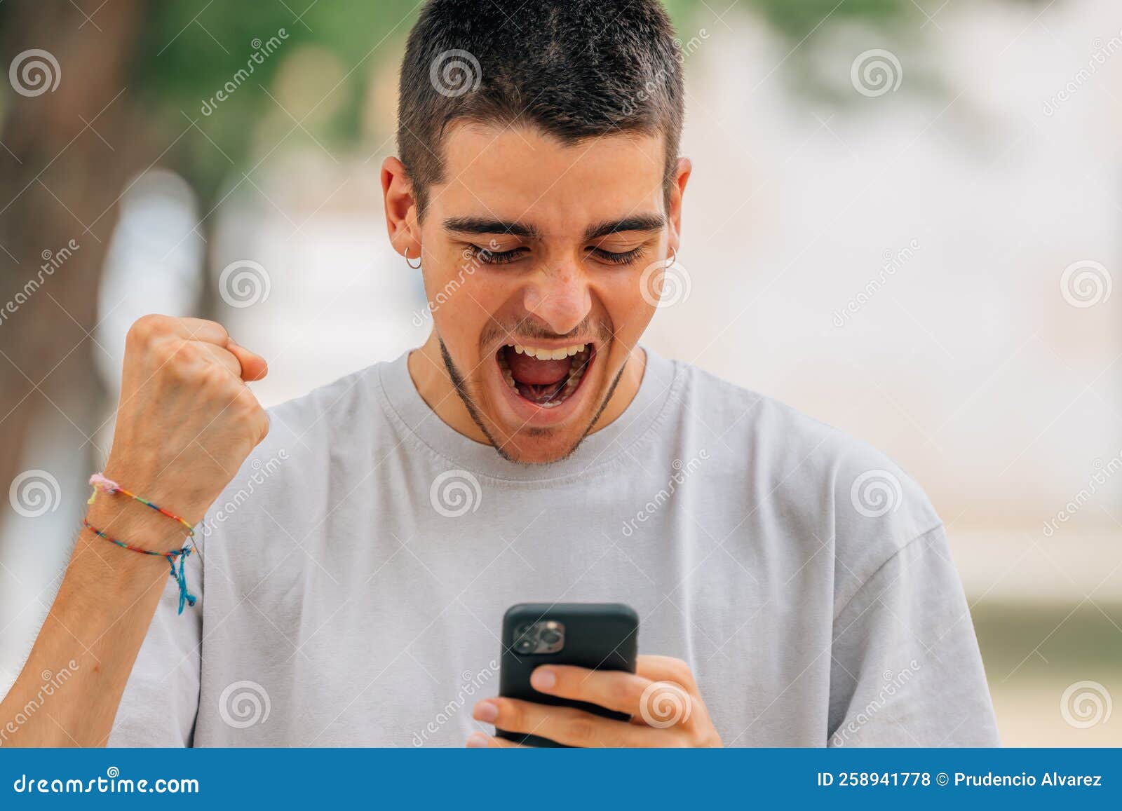 Man Excited with Joy Looking at the Mobile Phone Stock Photo - Image of ...