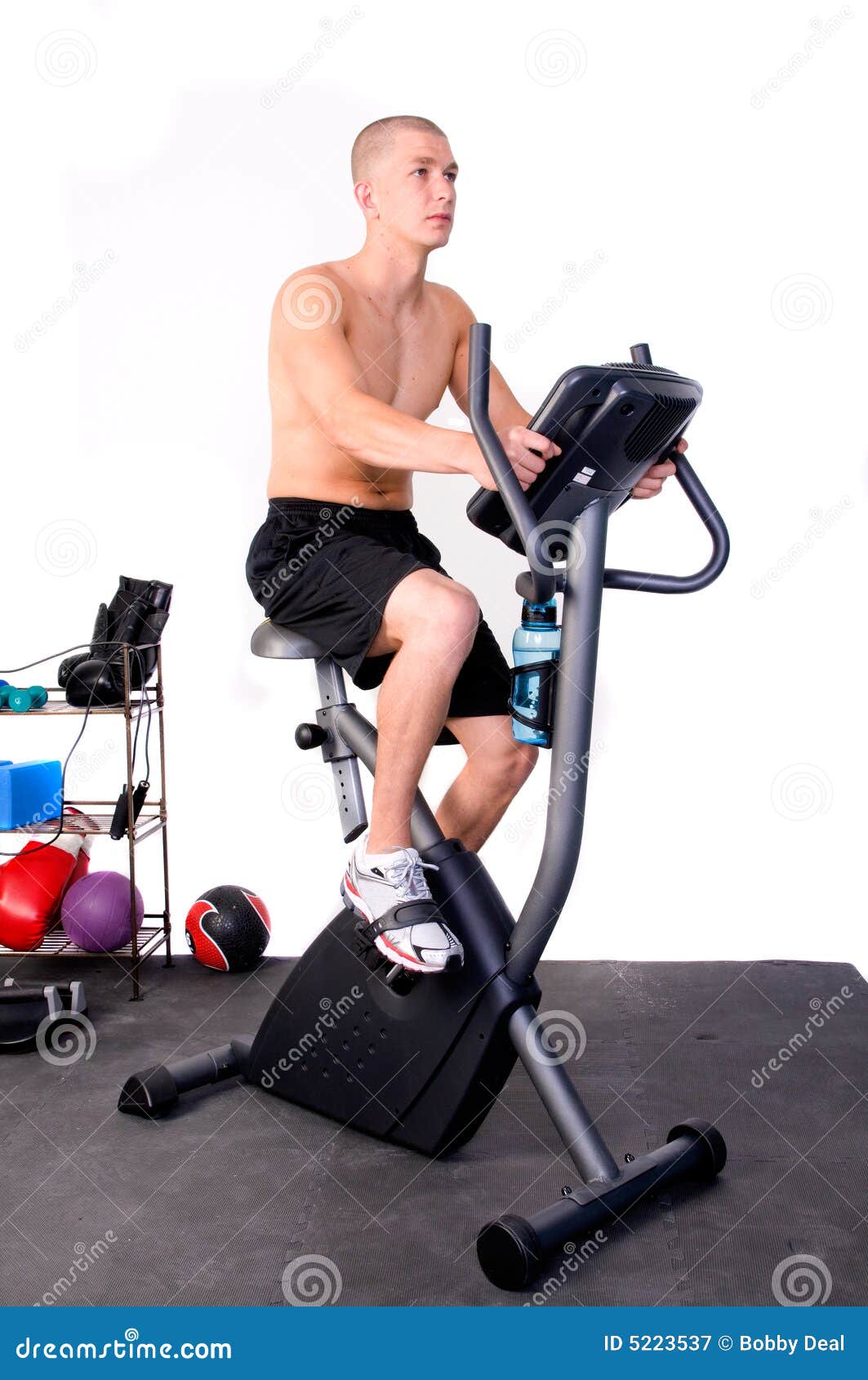Man on Exercises Bike stock image. Image of bottle, shorts - 5223537