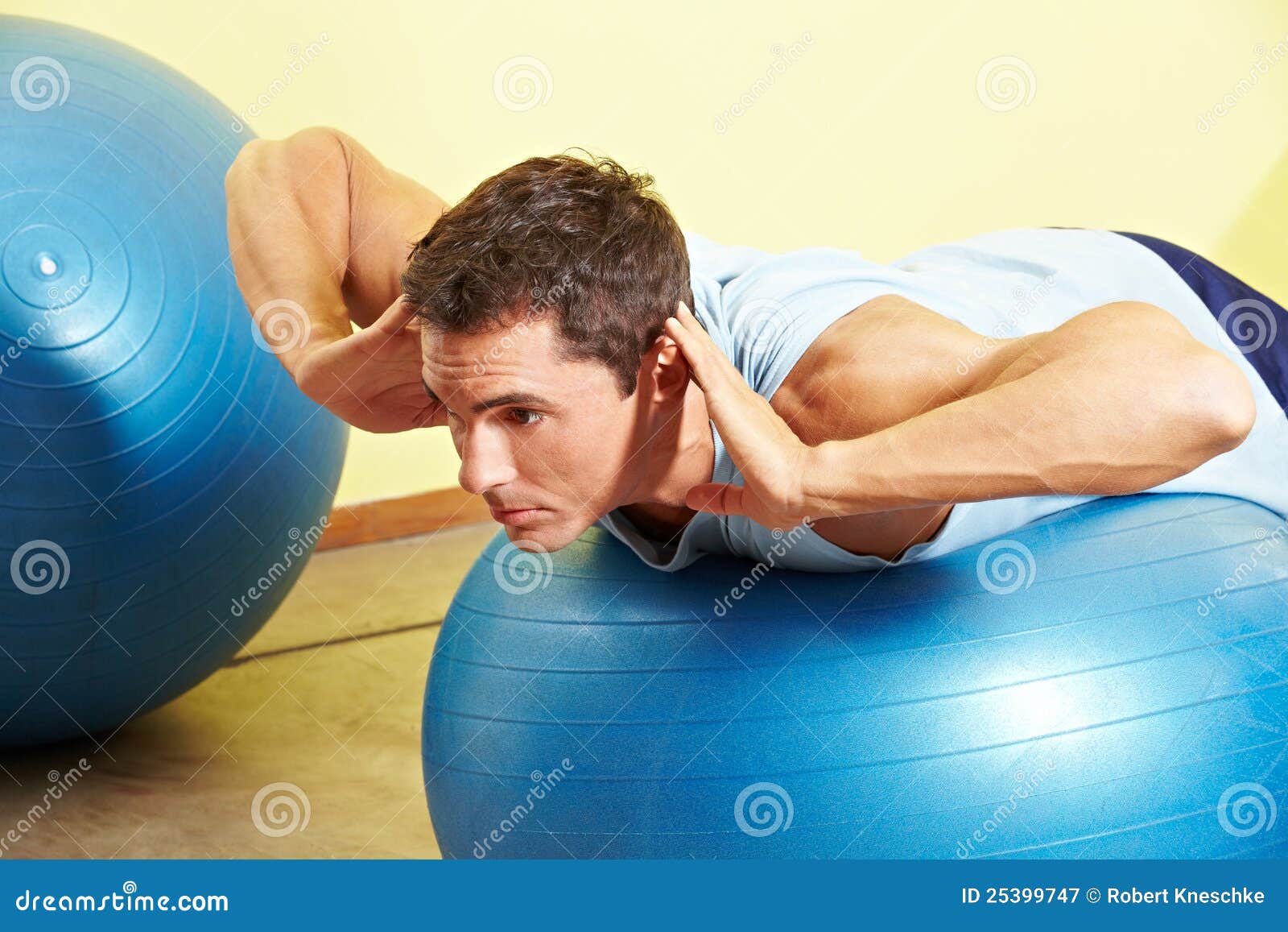 Man exercising on gym ball stock image. Image of press - 25399747