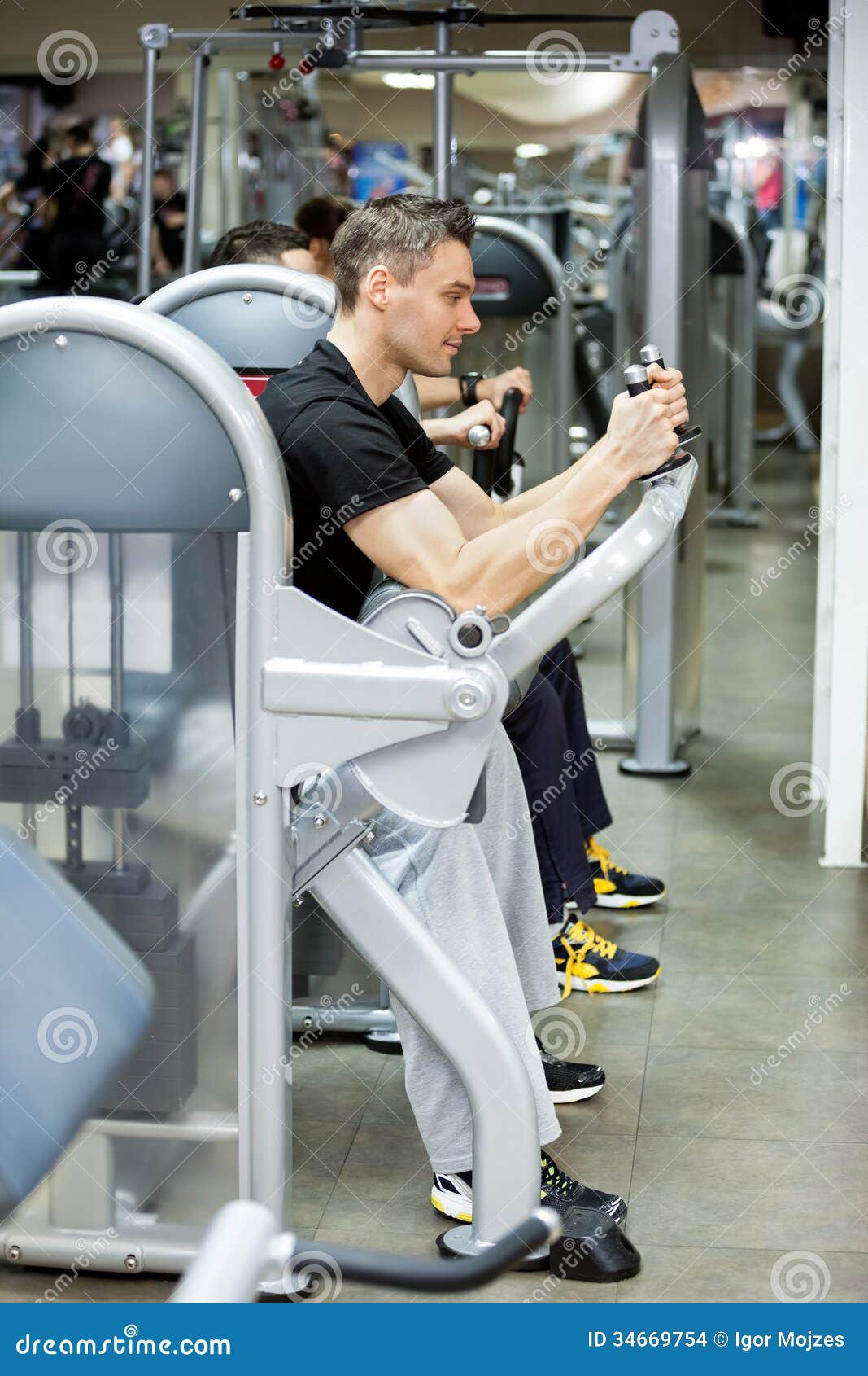 Man exercising on machines stock photo. Image of athlete - 34669754