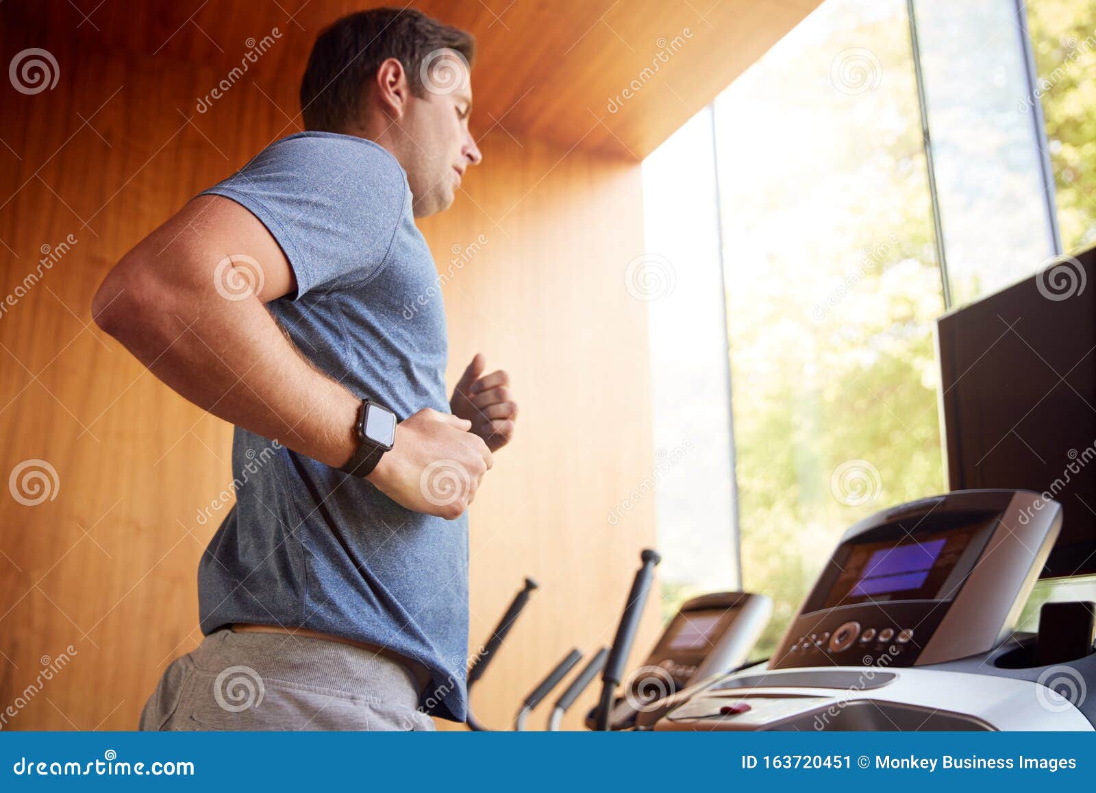 Man Exercising on Treadmill at Home Wearing Smart Watch Stock Image ...