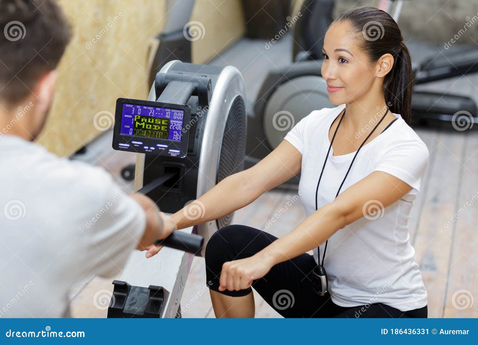 Man Exercising Using Rowing Machine Coached by Trainer Stock Image ...