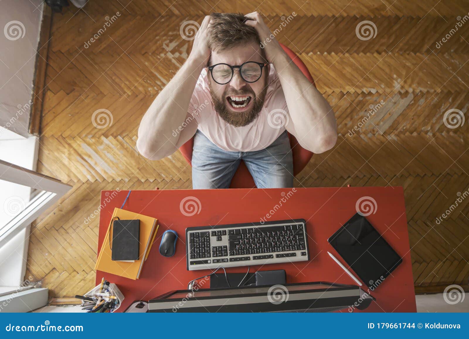 Man Experiences Stress Remotely Working at Home on a Computer, he is ...