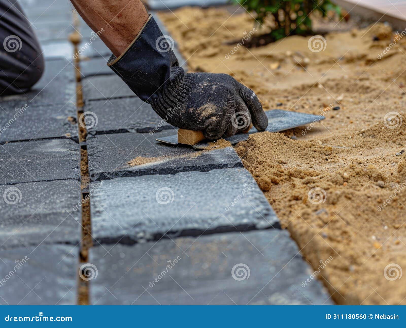A Man Expertly Lays Paving Stones on the Ground in a Precise Manner To ...