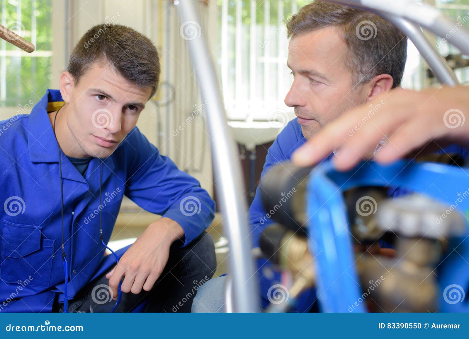 Man Explaining Controls Gas Bottle To Apprentice Stock Photo - Image of ...