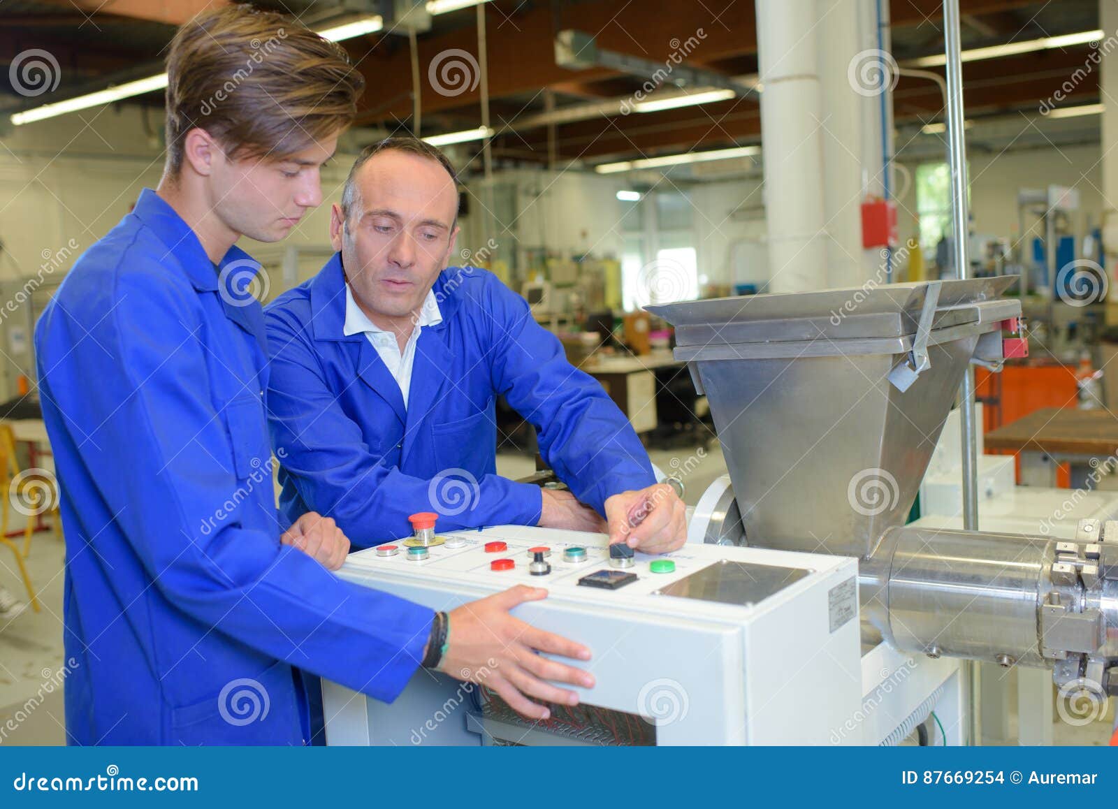 Man Explaining Controls Machine To Junior Worker Stock Photo - Image of ...