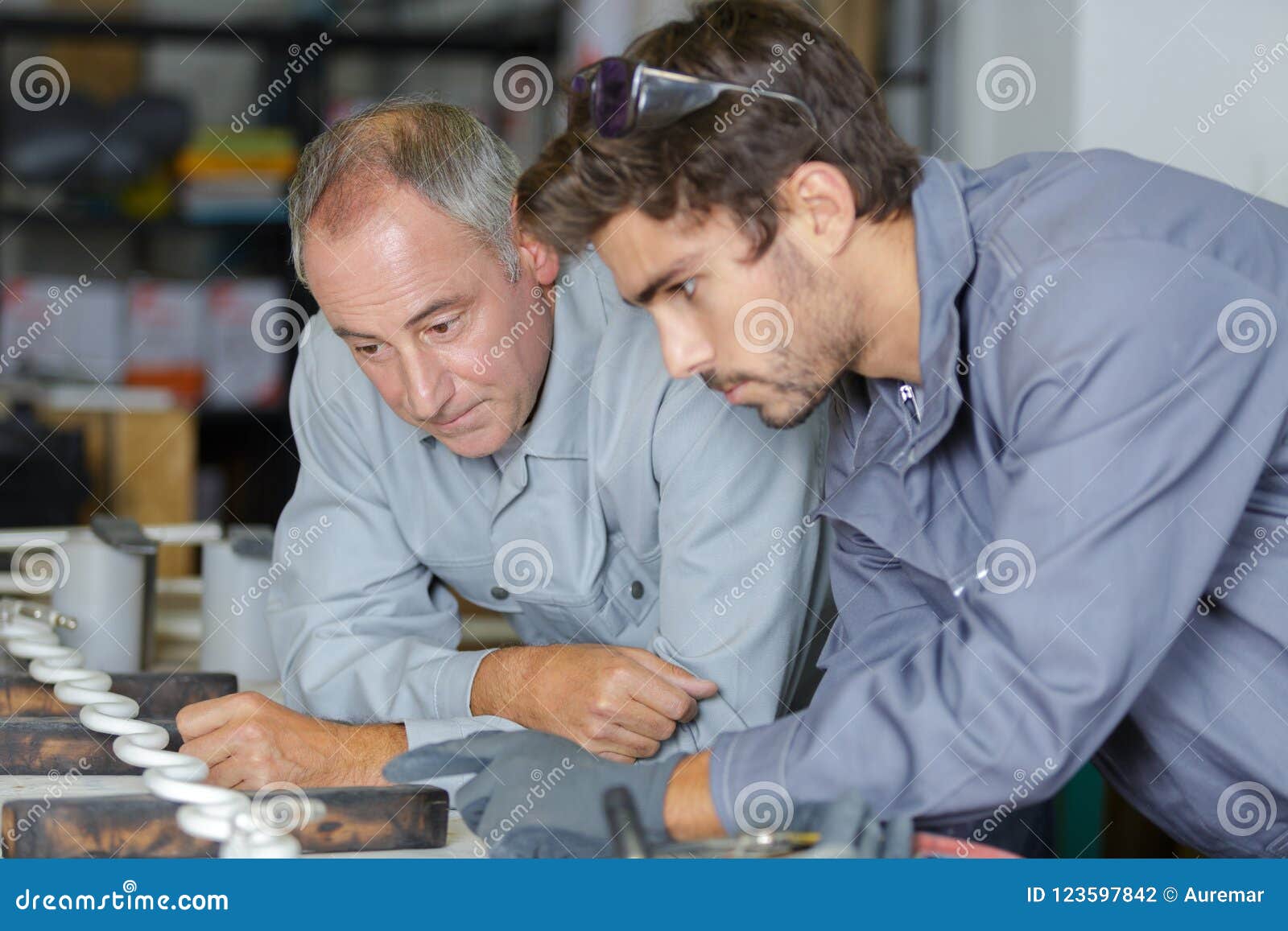 Man Explaining Equipment To Trainee Stock Photo - Image of gear ...