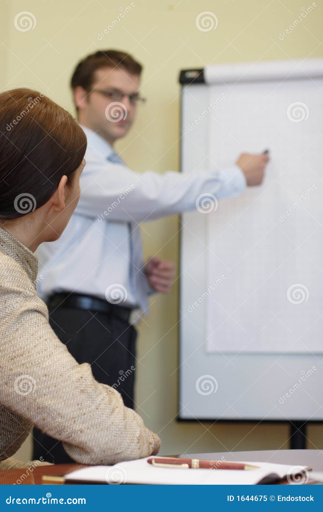 Man Explaining an Idea on Flip Chart To Woman Stock Image - Image of ...