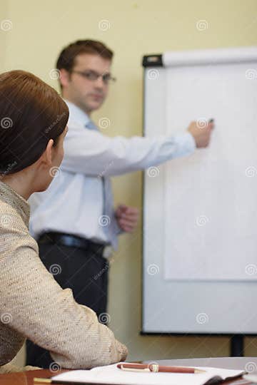 Man Explaining an Idea on Flip Chart To Woman Stock Image - Image of ...