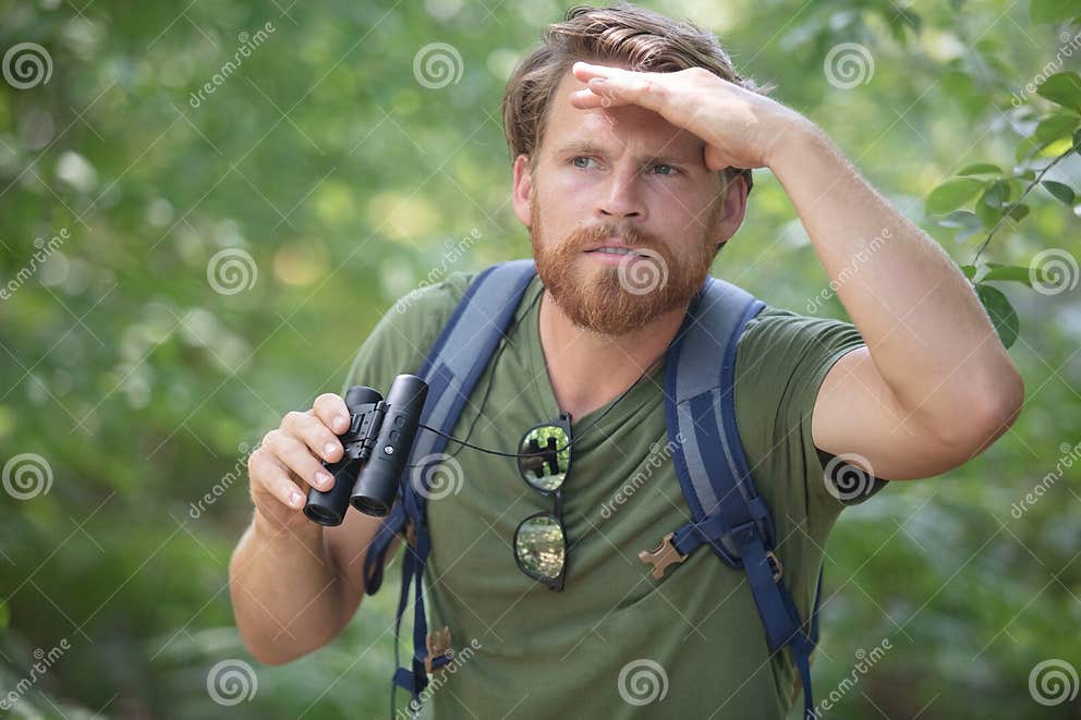 Man Explorer in Forest Scanning Horizon with Binoculars Stock Image ...