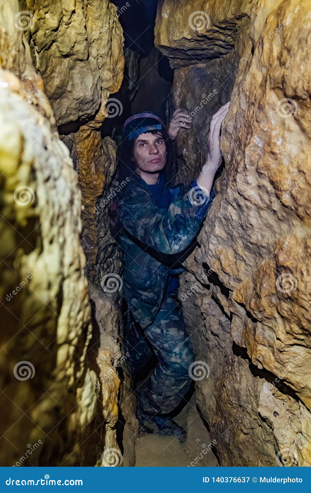 Man explores narrow cave stock image. Image of geology - 140376637