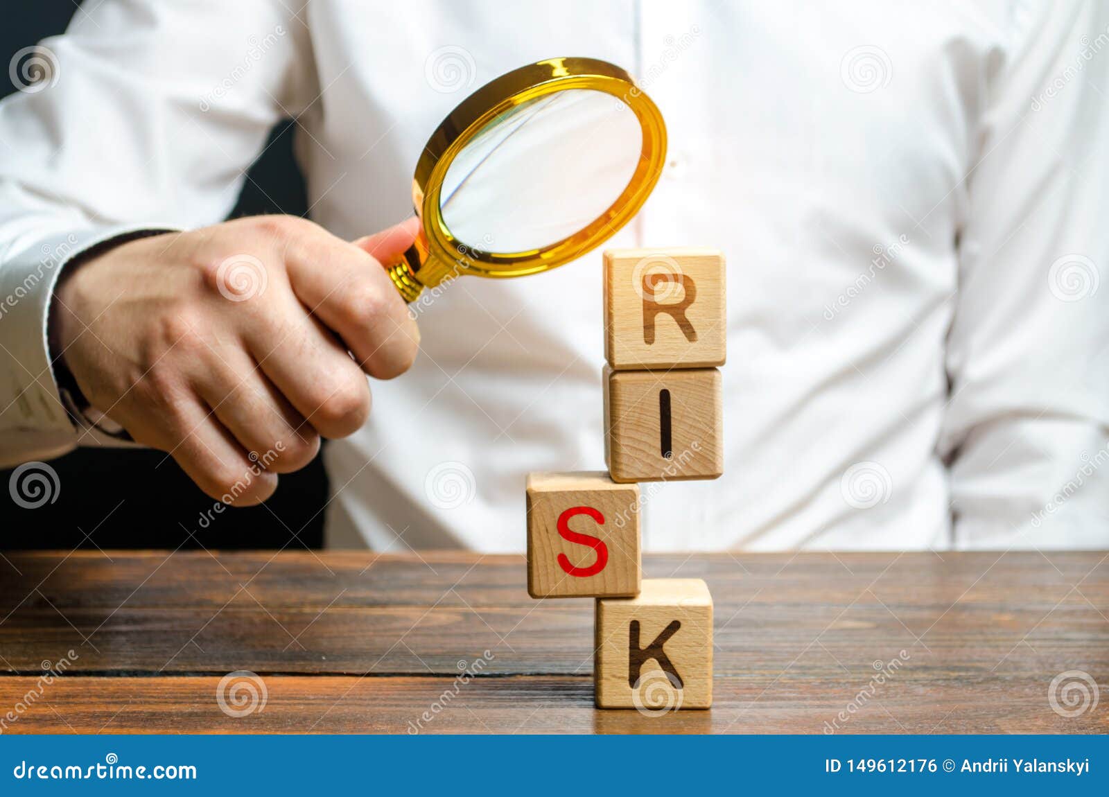 A Man Explores A Tower Of Cubes With The Word Risk. Search And ...
