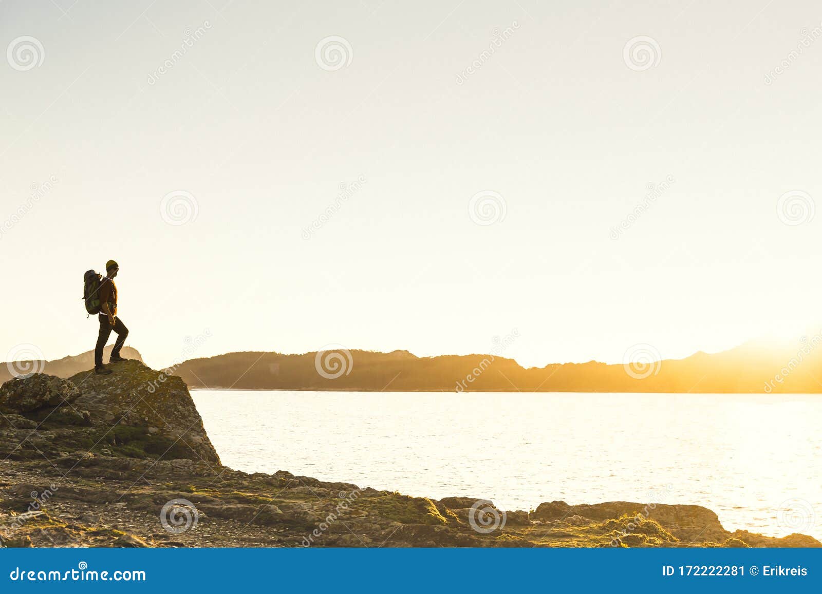 Man Exploring the Coast Line at Sunset Stock Image - Image of ...