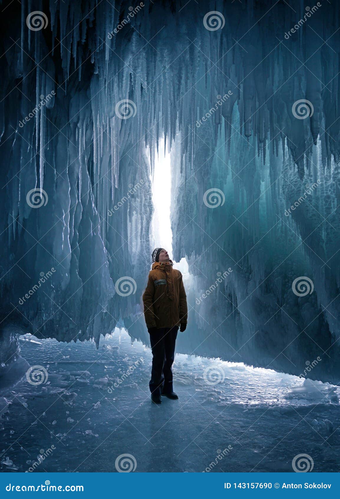 Man exploring ice cave stock photo. Image of tourist - 143157690