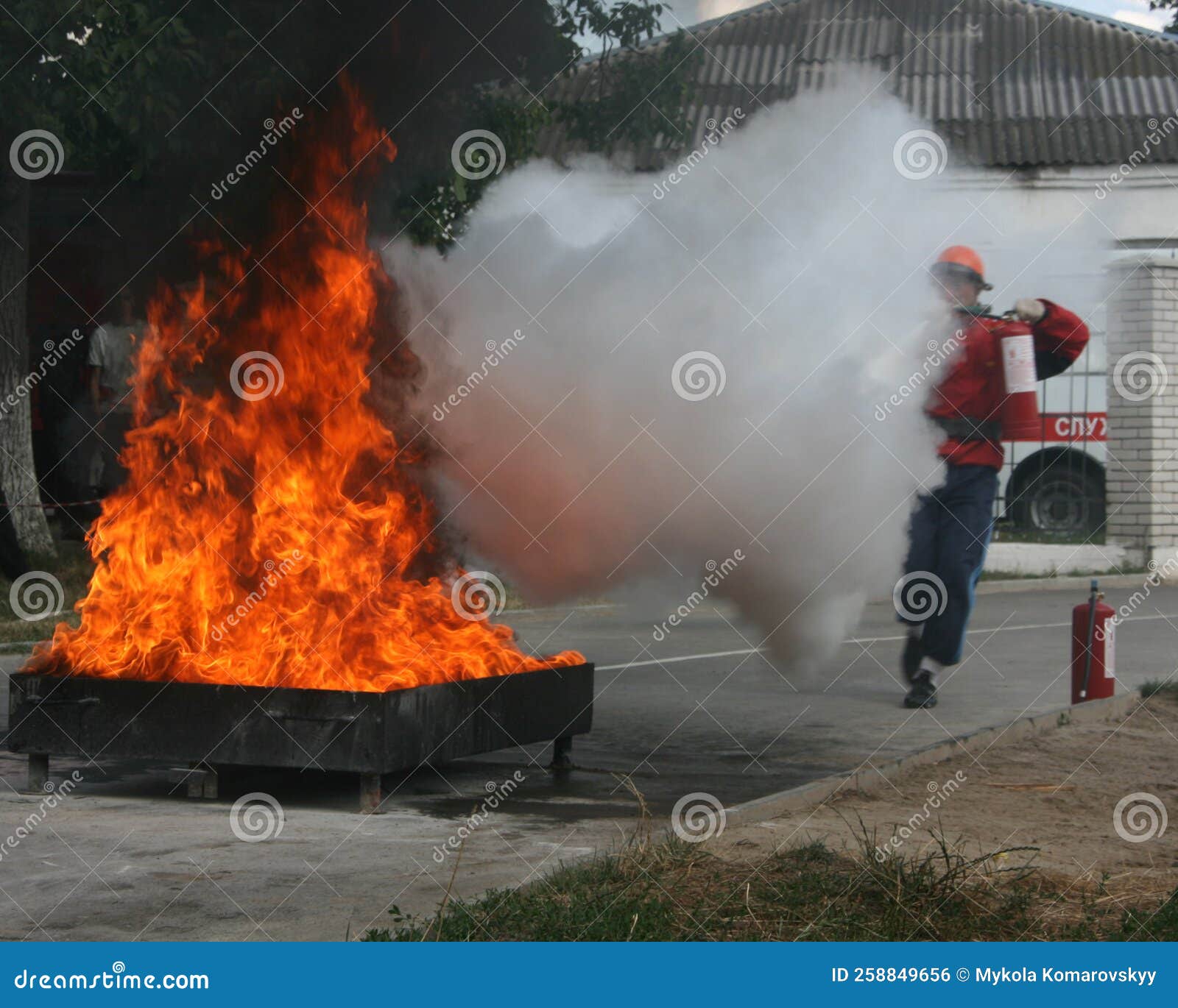 Man with extinguisher stock photo. Image of emergency - 258849656
