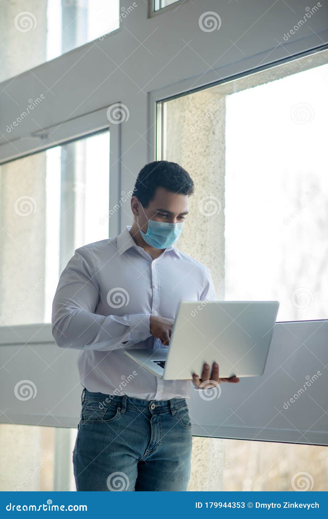 Man in a Facial Mask Standing with a Laptop Stock Image - Image of ...