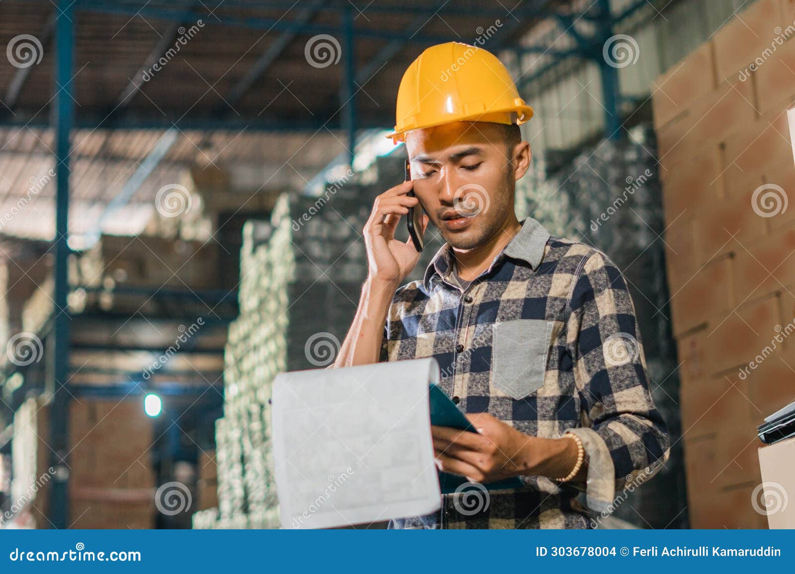 Man Factory Worker on Phone while Working Checking Data of Goods Stock ...