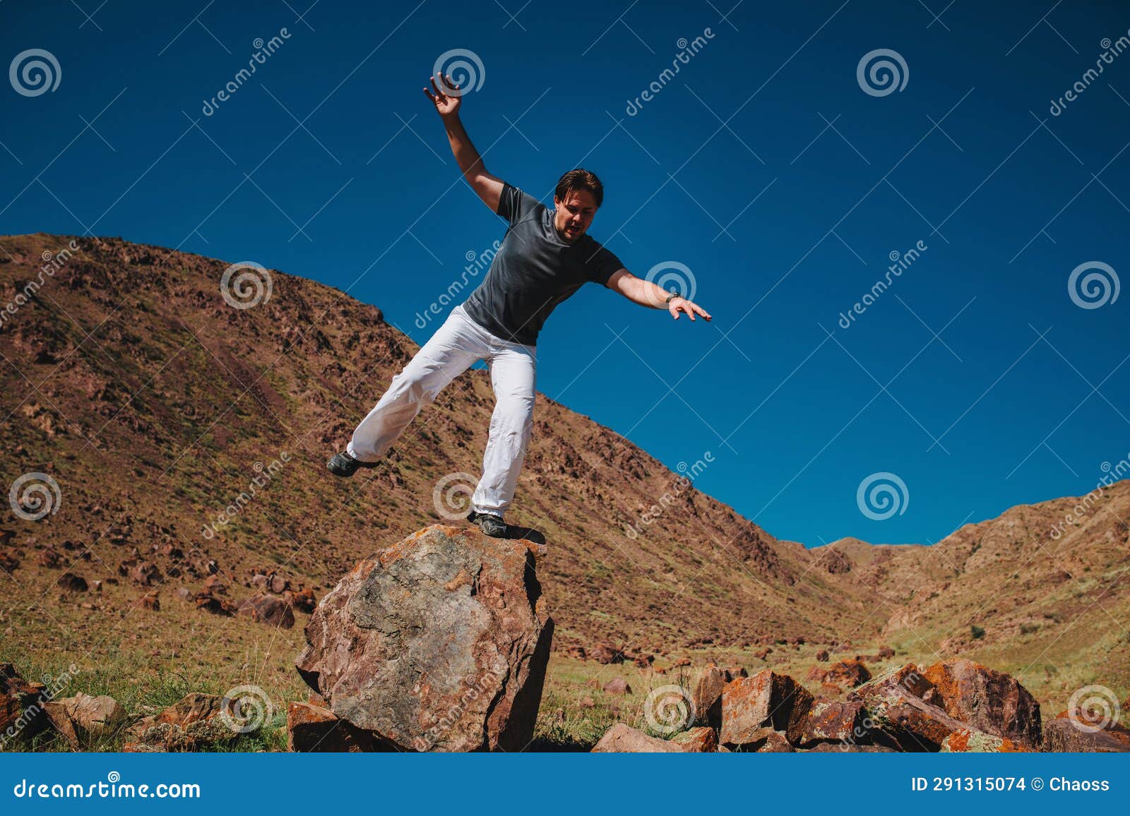 Man Falling from Big Stone in the Mountains Stock Photo - Image of ...