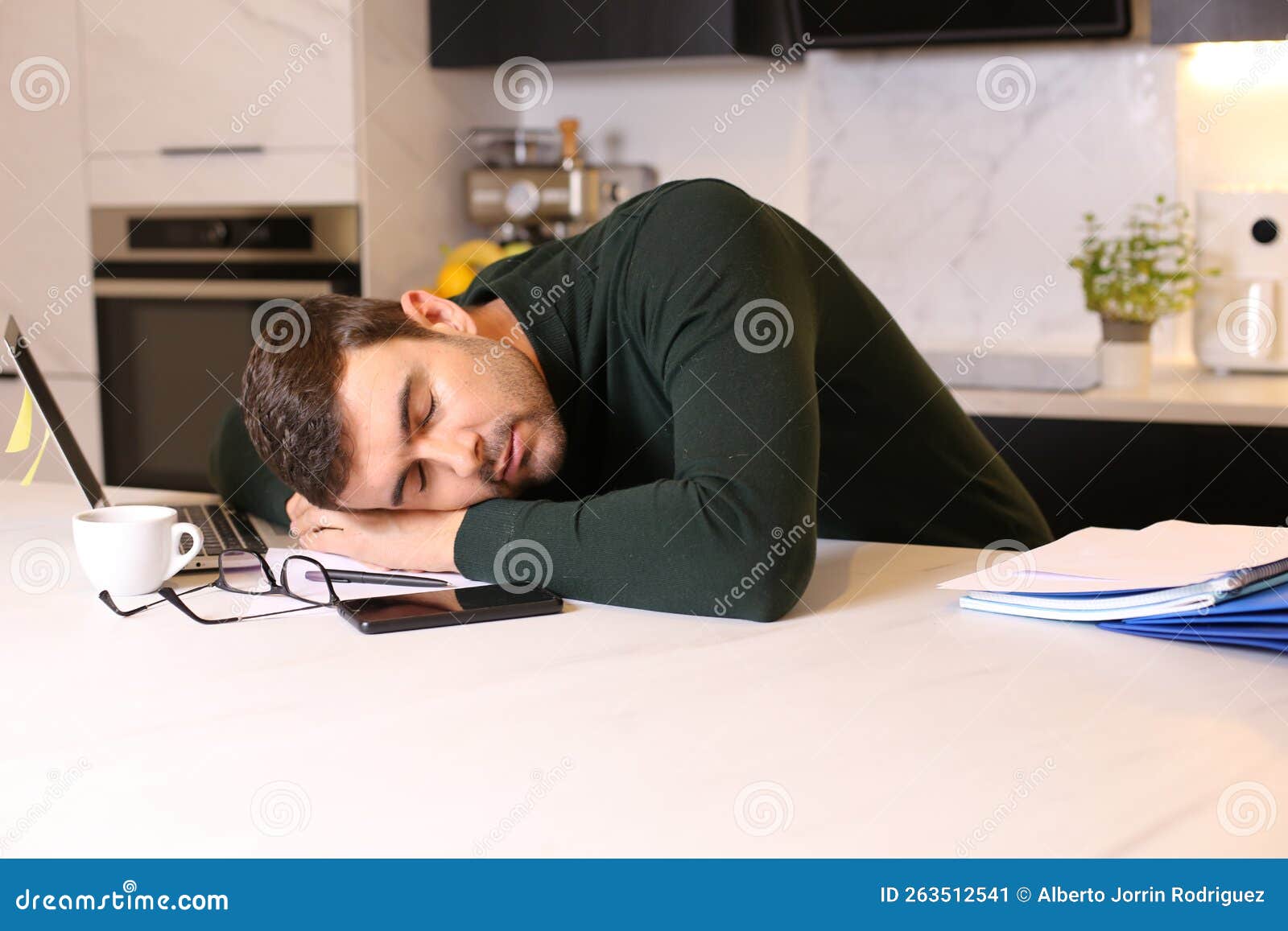 Man Falling Sleep while Working Remotely from His Kitchen Stock Image ...