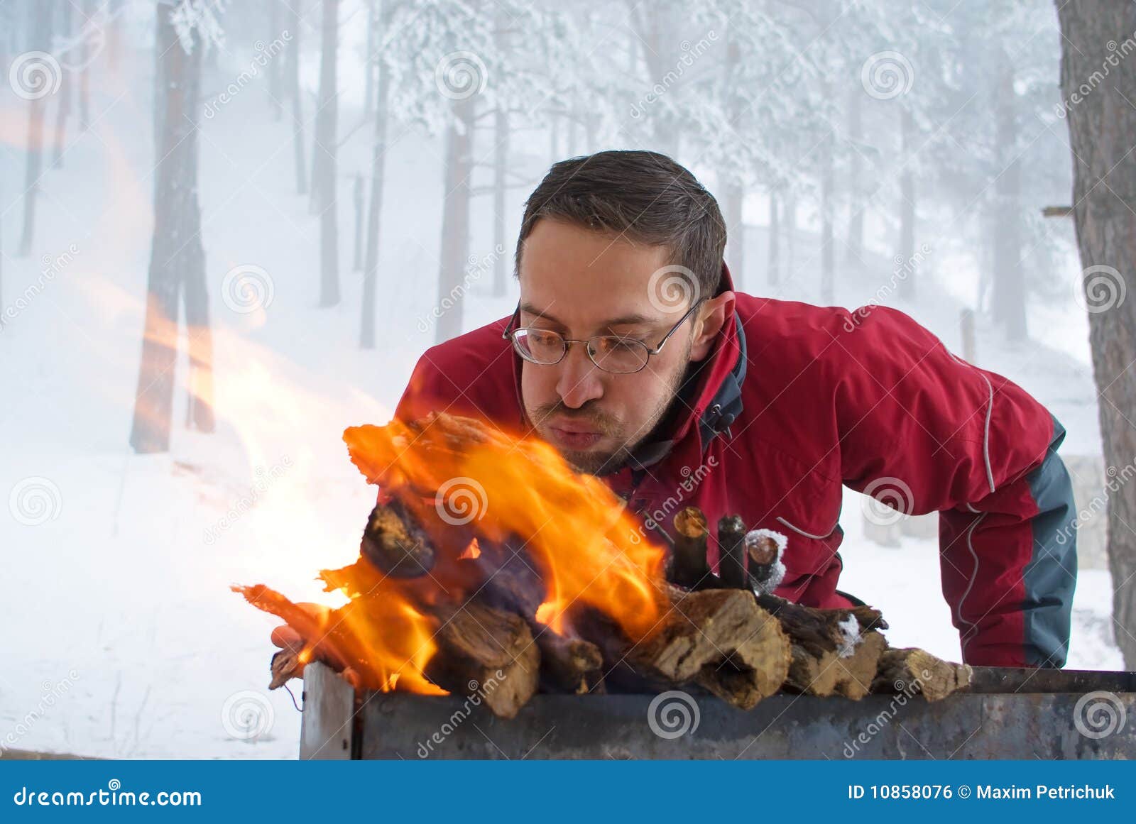 Man fanning fire in grill stock photo. Image of adult - 10858076