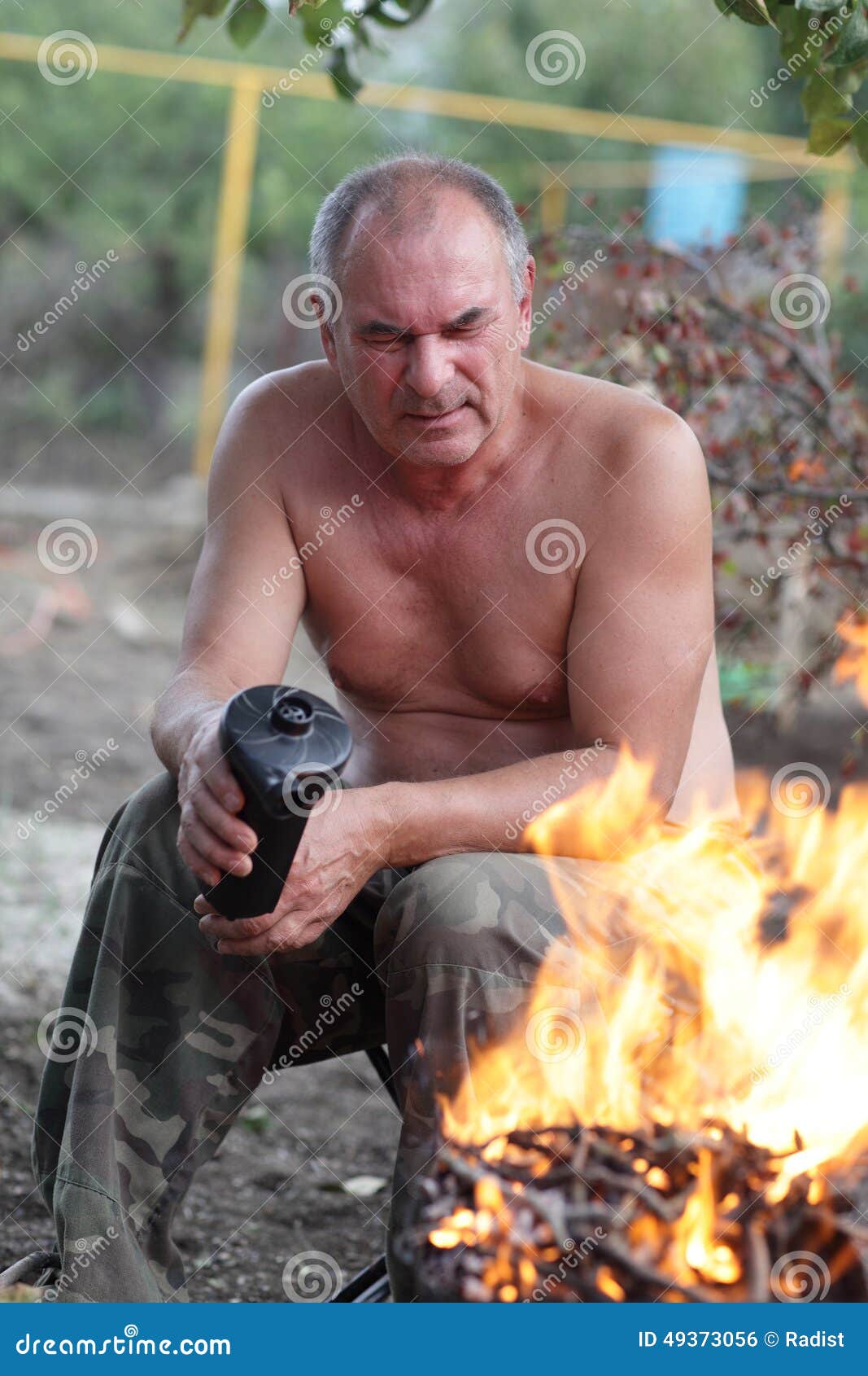 Man Fanning the Fire at Picnic Stock Photo - Image of activity, food ...