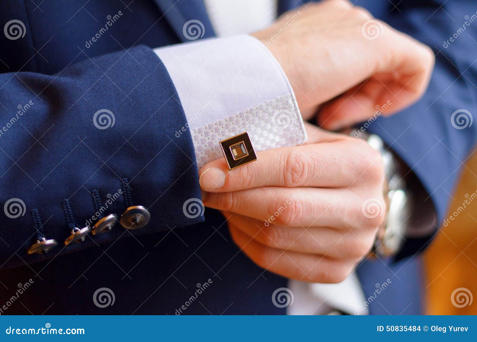A man fastens a cuff-link stock photo. Image of appointment - 50835484