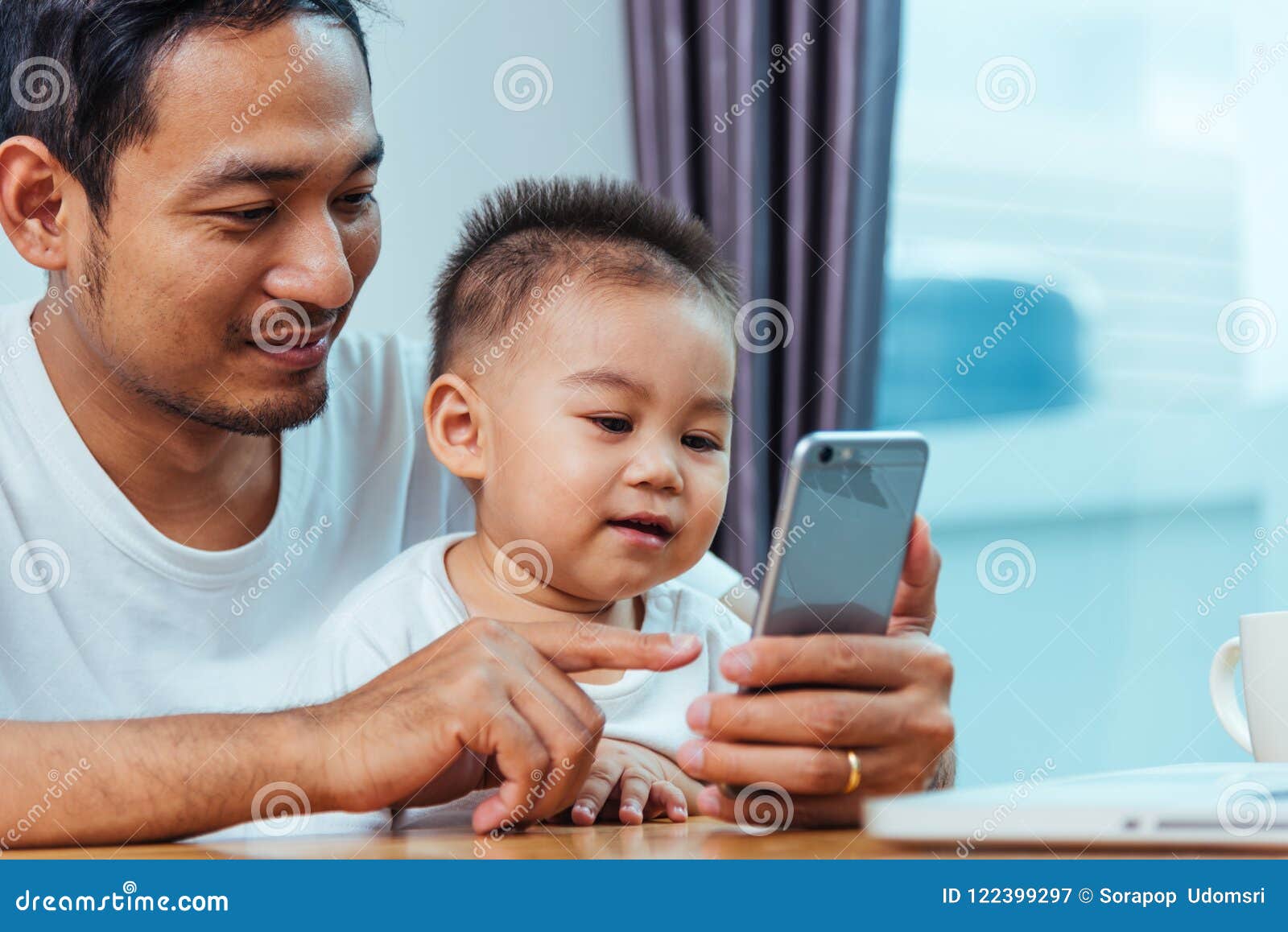 Man Father Working on Laptop Computer and Using Smartphone Technology ...