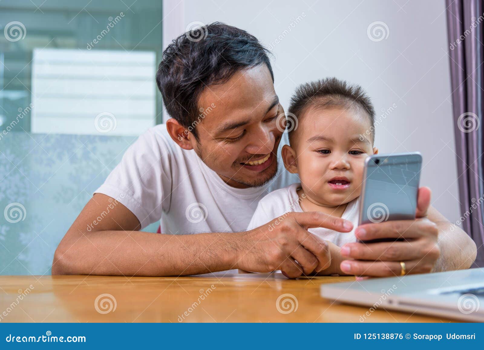 Man Father Working on Laptop Computer and Using Smartphone Technology ...