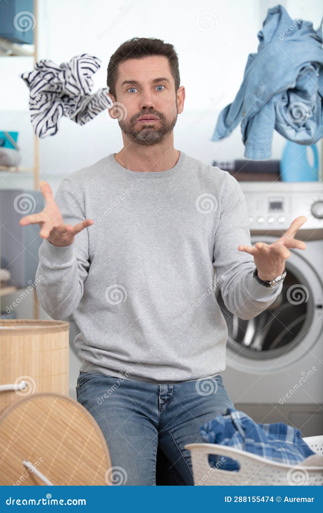 Man fed up doing laundry stock photo. Image of people - 288155474