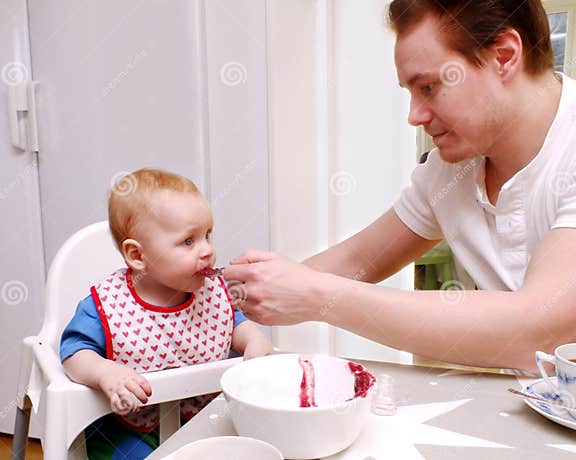 Man feeding baby stock image. Image of parenting, young - 23594821