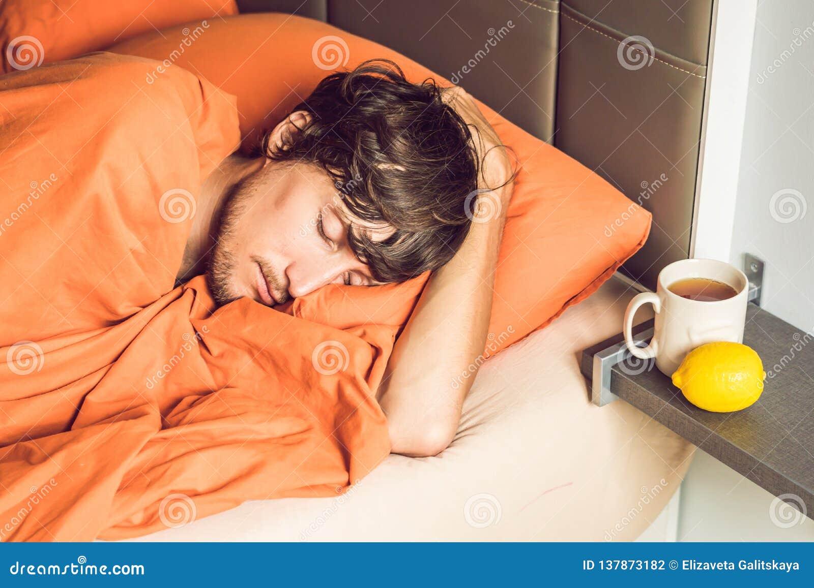 Man Feeling Cold, Lying in the Bed and Drinks Tea and Measures ...