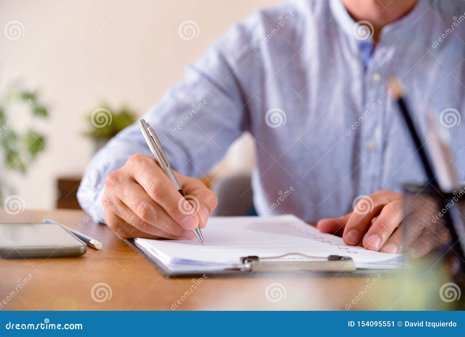 Man Filling Out a Questionnaire on a Wooden Table Front Stock Image ... Man Filling Out a Questionnaire on a Wooden Table Front Stock Image ...
