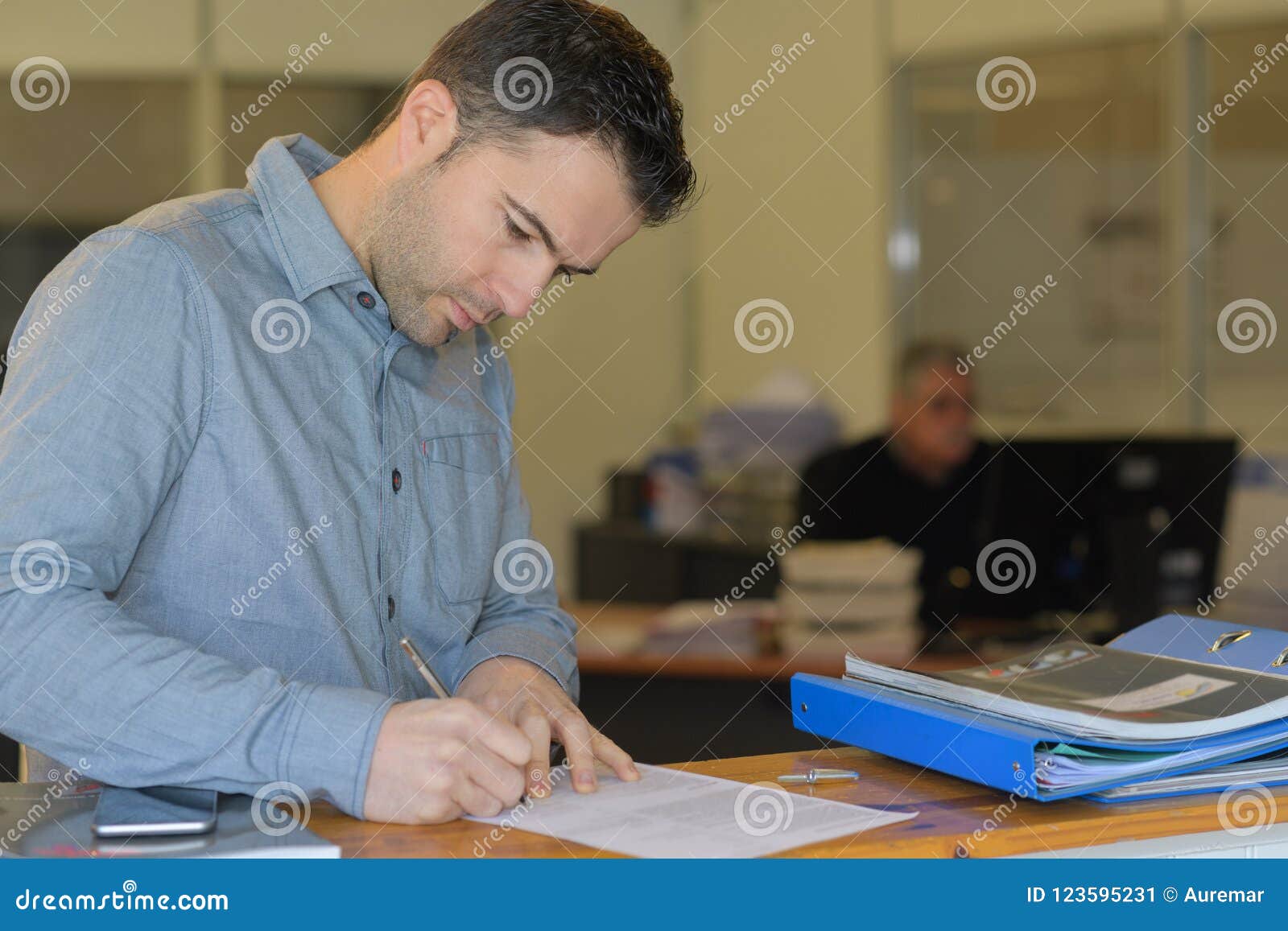 Man filling up form stock image. Image of signature - 123595231