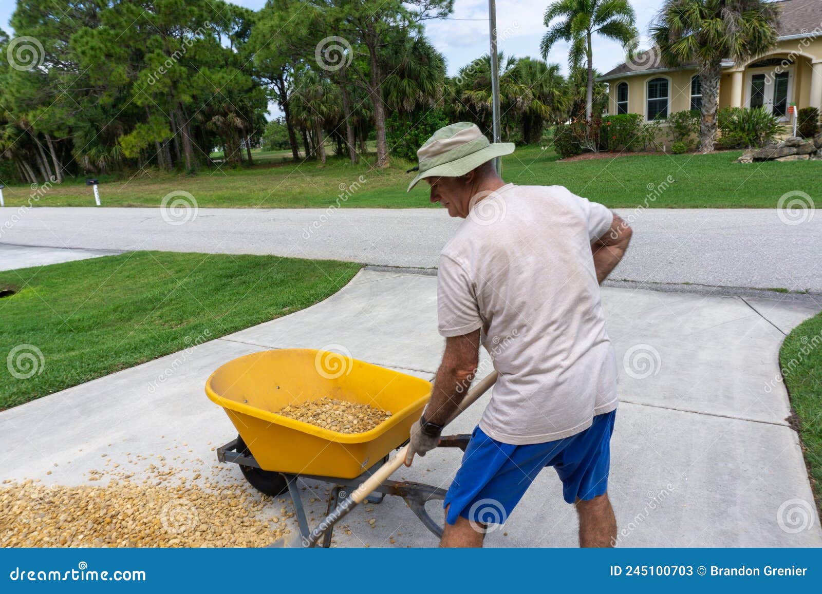 Man Fills Wheelbarrow with Rocks Stock Image - Image of outdoors ...