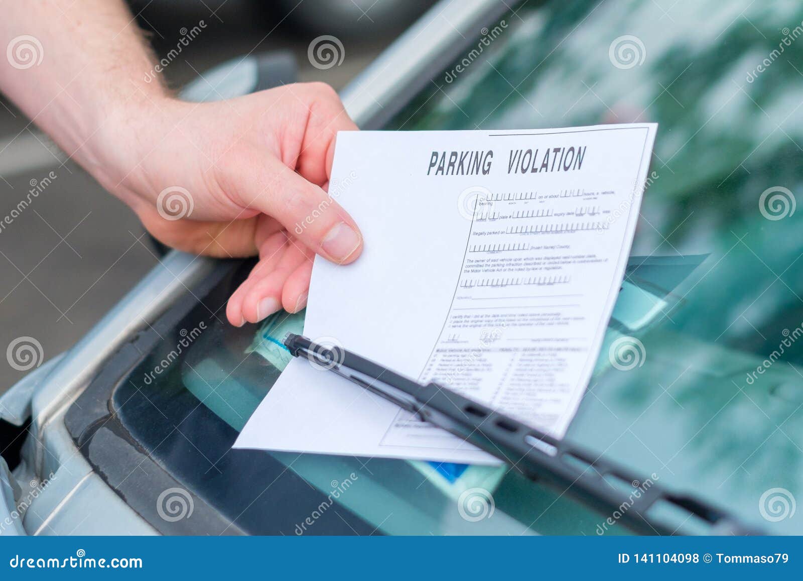 Man Finding a Ticket Fine Under the Car Windscreen because of Parking ...