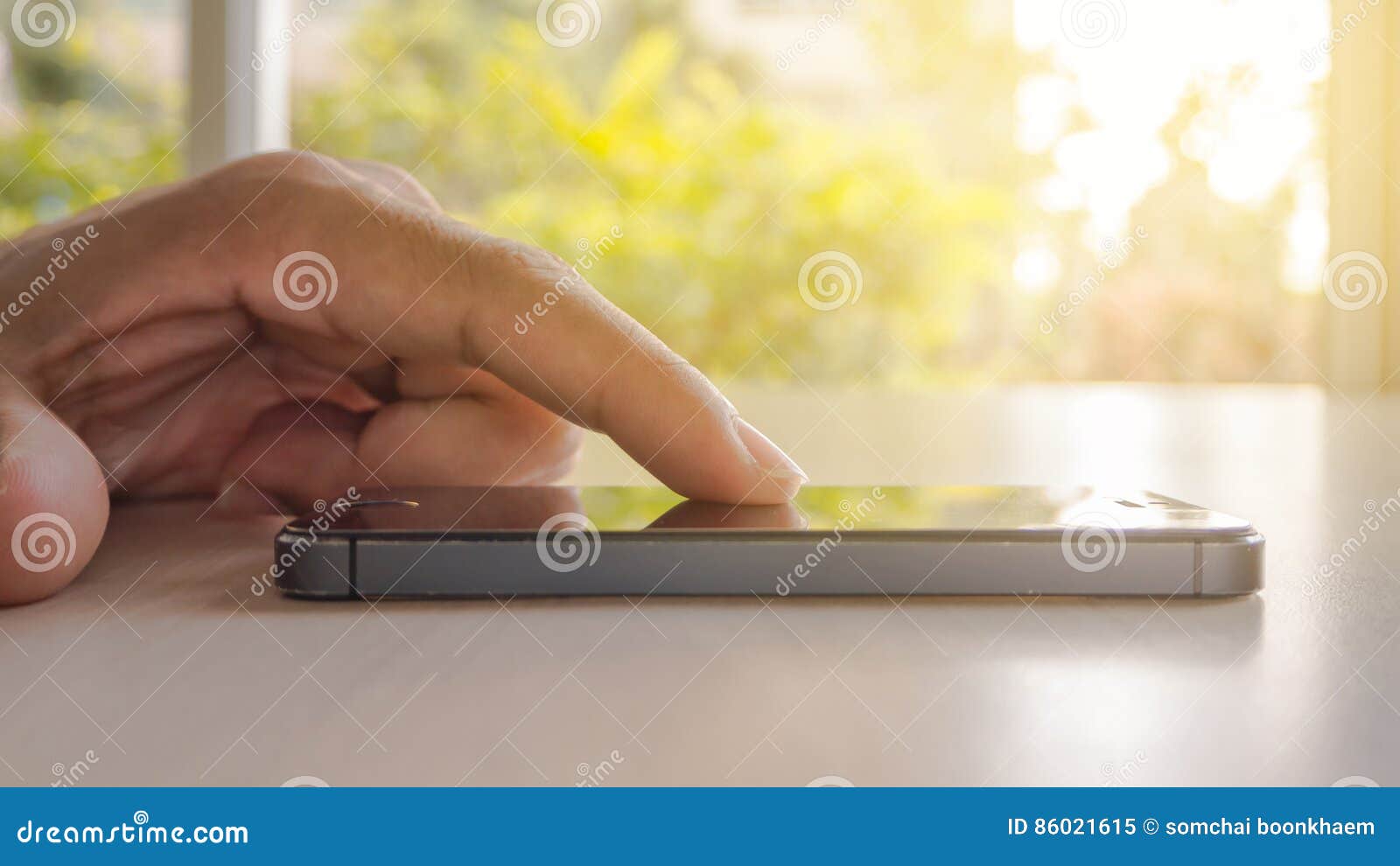 Man Finger Touching the Screen of a Smart-phone on the D Stock Image ...