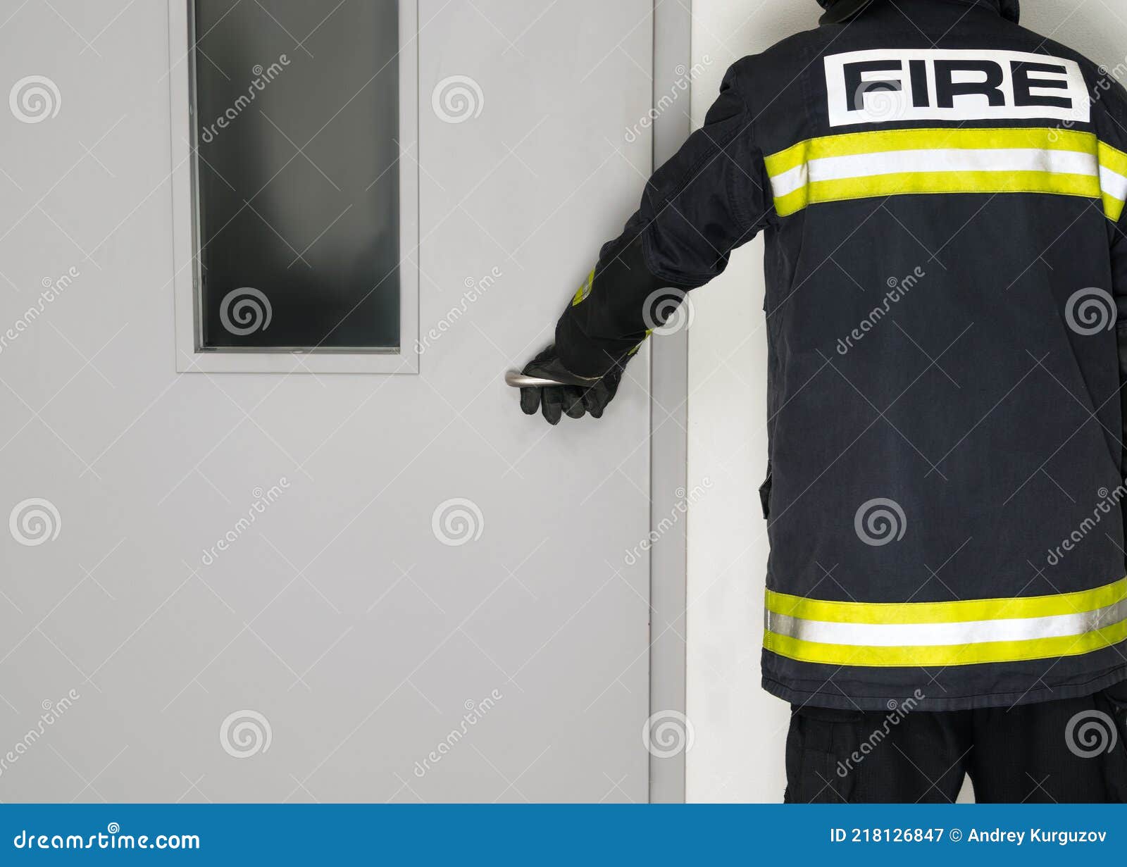 A Man In A Fireman`s Uniform Opens The Door, Rear View Royalty-Free ...