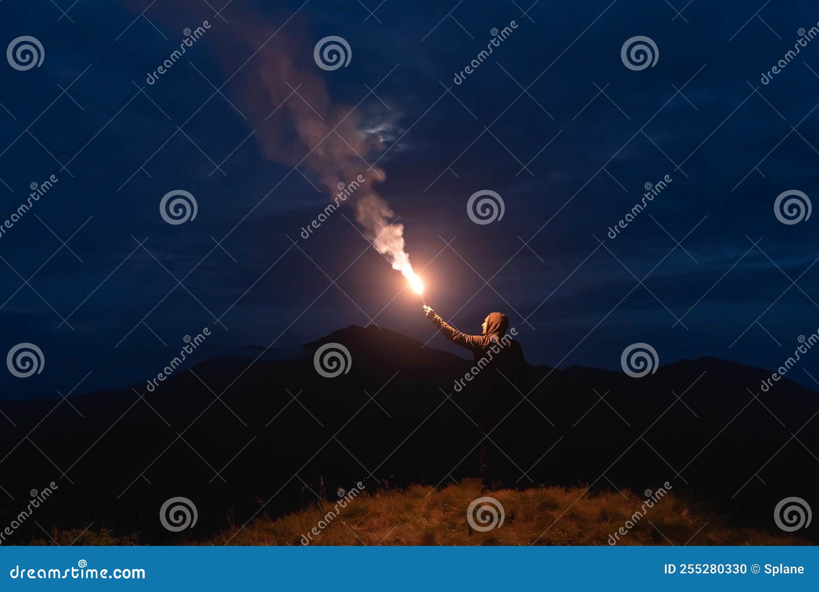 The Man with a Firework Stick Standing on a Mountain. Stock Photo ...