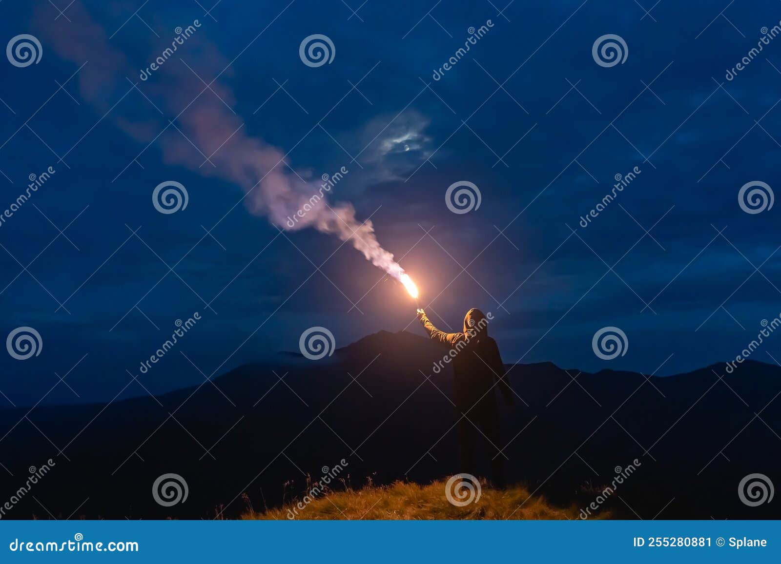 The Man with a Firework Stick Standing on a Mountain. Stock Image ...