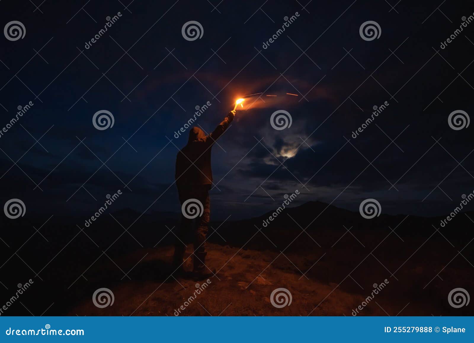 The Man with a Firework Stick Standing on the Night Mountain. Stock ...